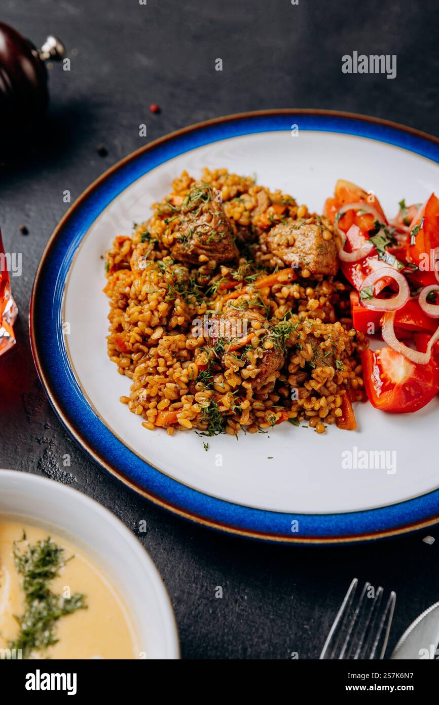 Savory bulgur pilaf with tender beef and fresh tomato salad,perfect for ...