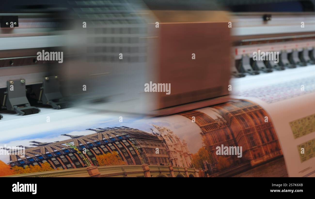 A printer is printing a picture of a city. The printer is in motion ...