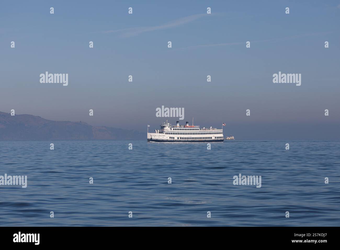 Tourist ferry boat crosses bay Stock Photo - Alamy