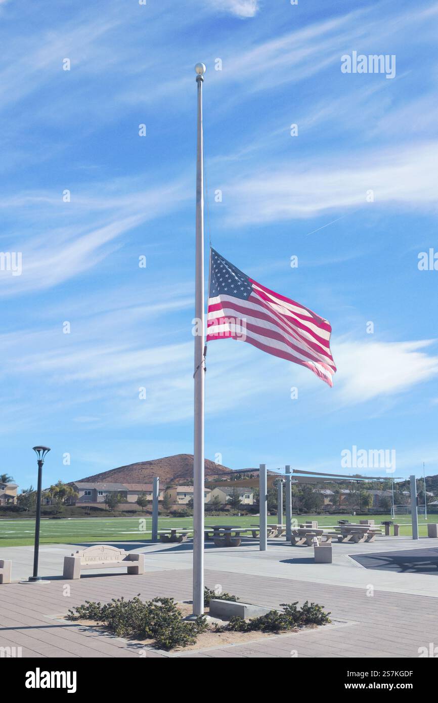 US Flag flying at half staff in memoriam in public park Stock Photo - Alamy