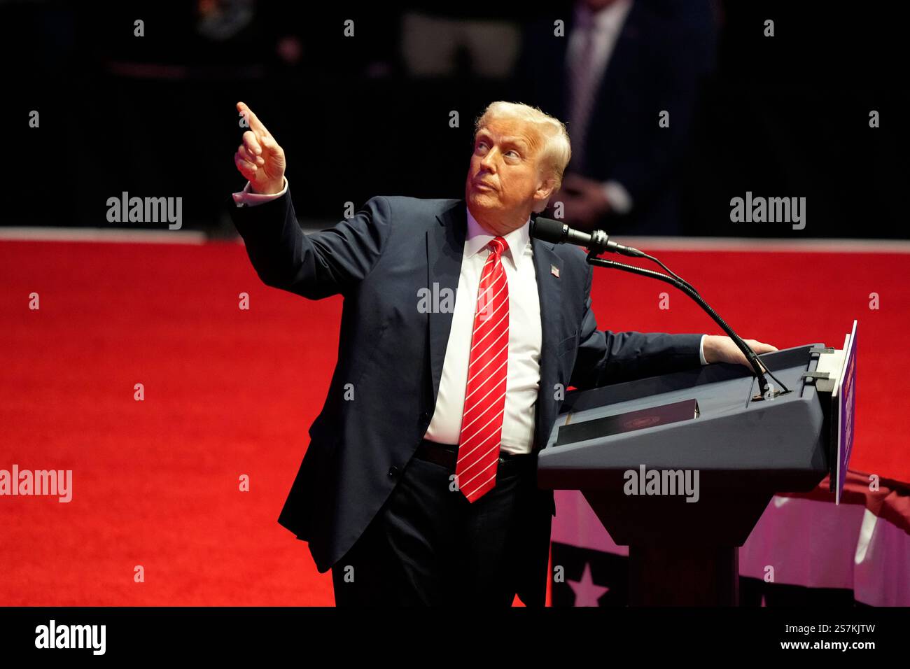 President-elect Donald Trump points to a chart on screen as he speaks ...