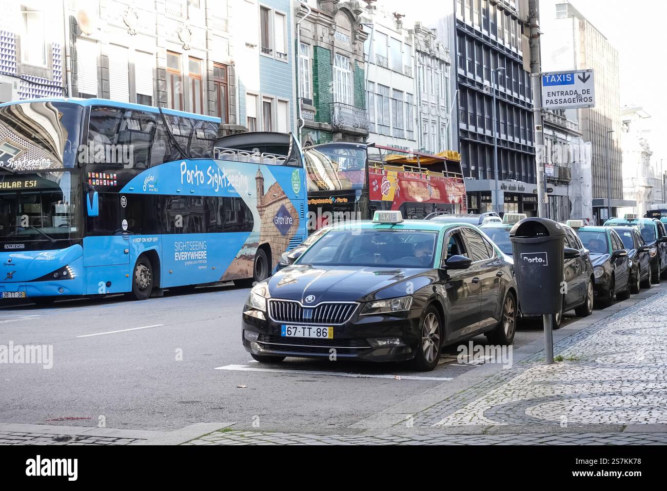 Line of taxis parked on street, waiting for tourists, sightseeing buses ...