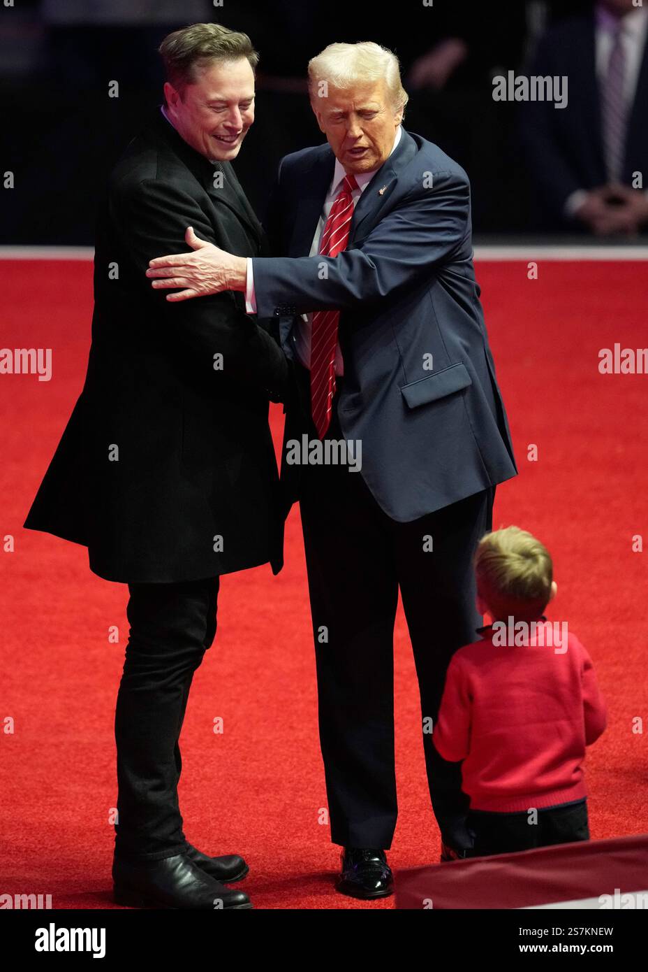 Elon Musk, left, and President-elect Donald Trump embrace as they look ...