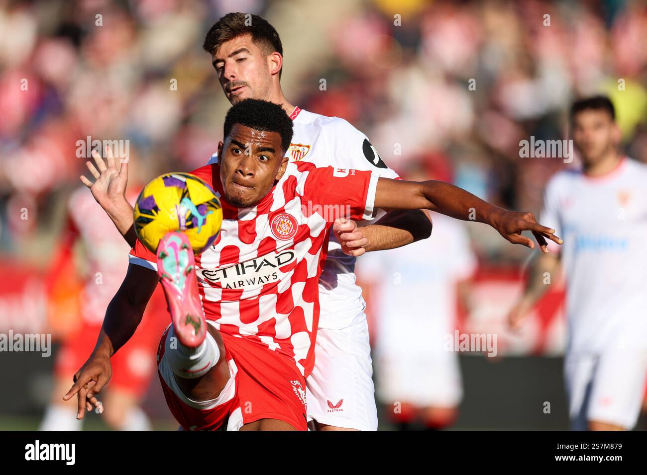 Girona, Spain. 18th Jan, 2025. Jhon Elmer Solis of Girona FC and Enrique Salas Kika of Sevilla ...