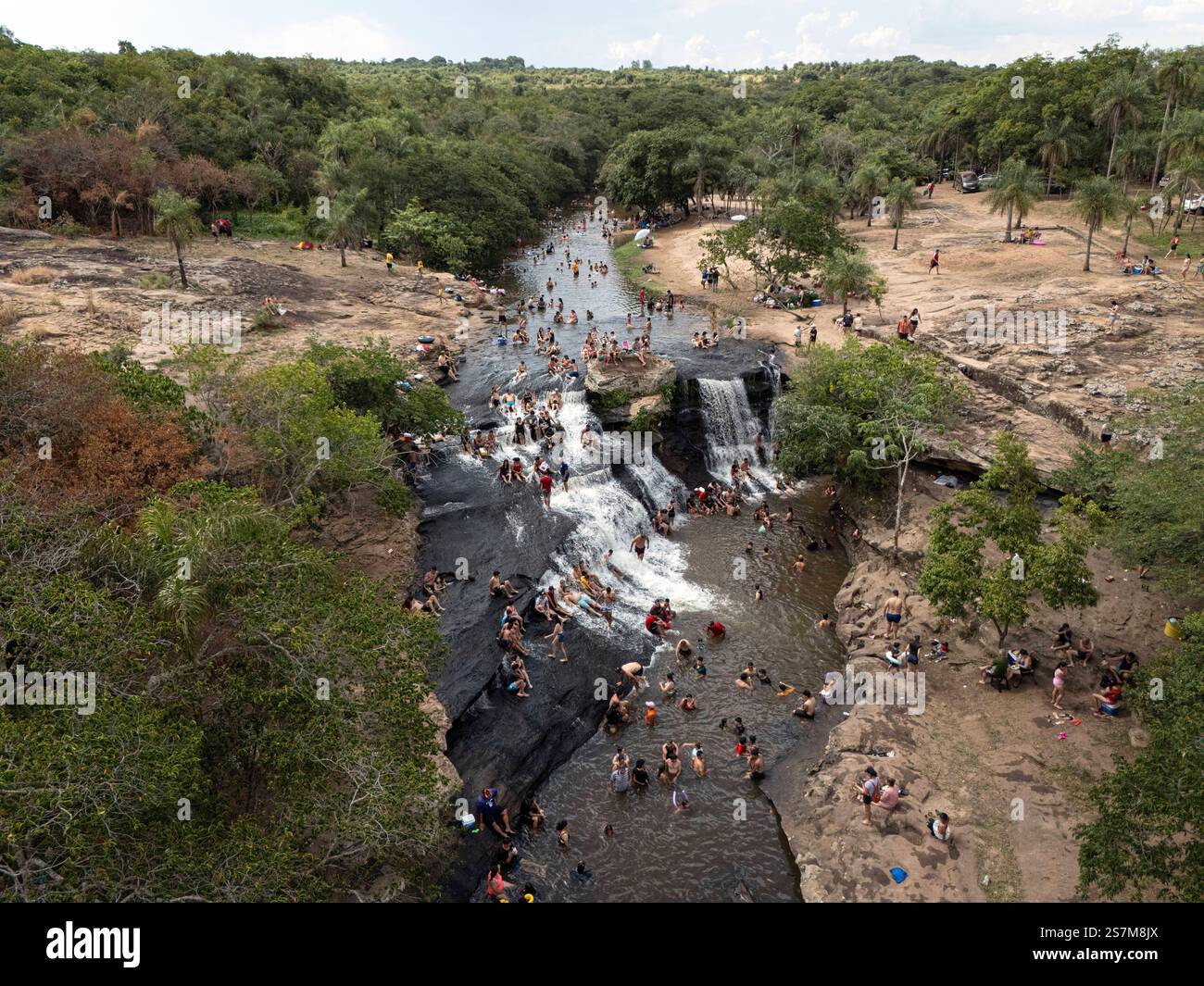 People cool off in the Saltos del Pirareta stream on a summer afternoon ...