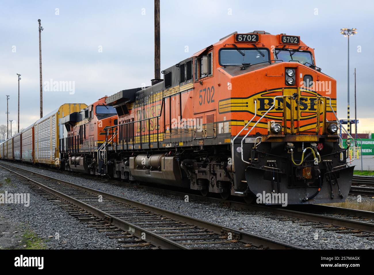Tacoma, WA, USA - January 14, 2025; BNSF autorack vehicle freight train behind diesel locomotive ...