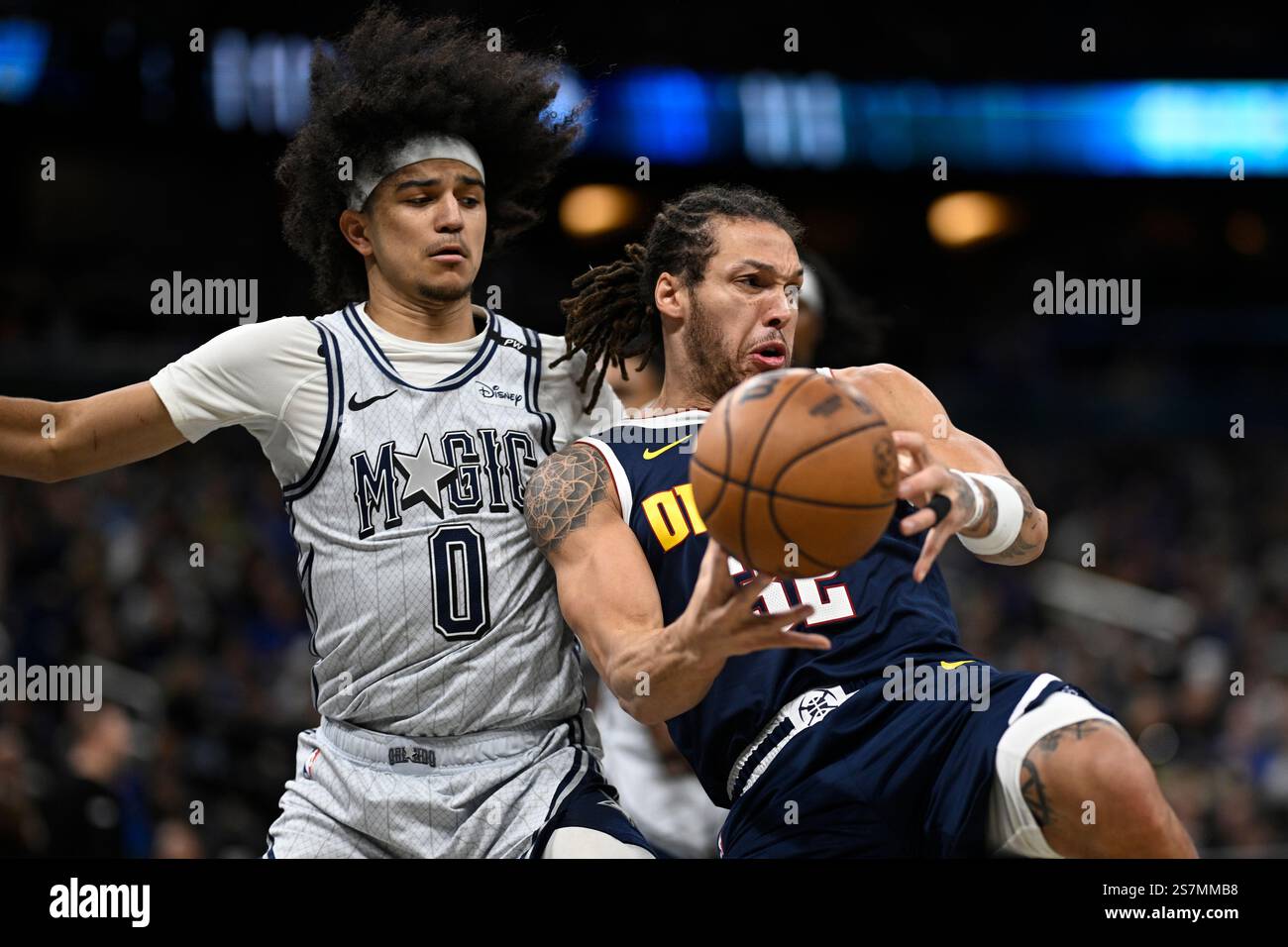 Denver Nuggets forward Aaron Gordon, right,loses control of the ball as ...