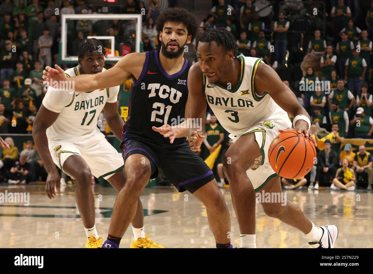 Baylor guard Jeremy Roach (3) drives the ball against TCU guard Noah Reynolds (21) during the ...