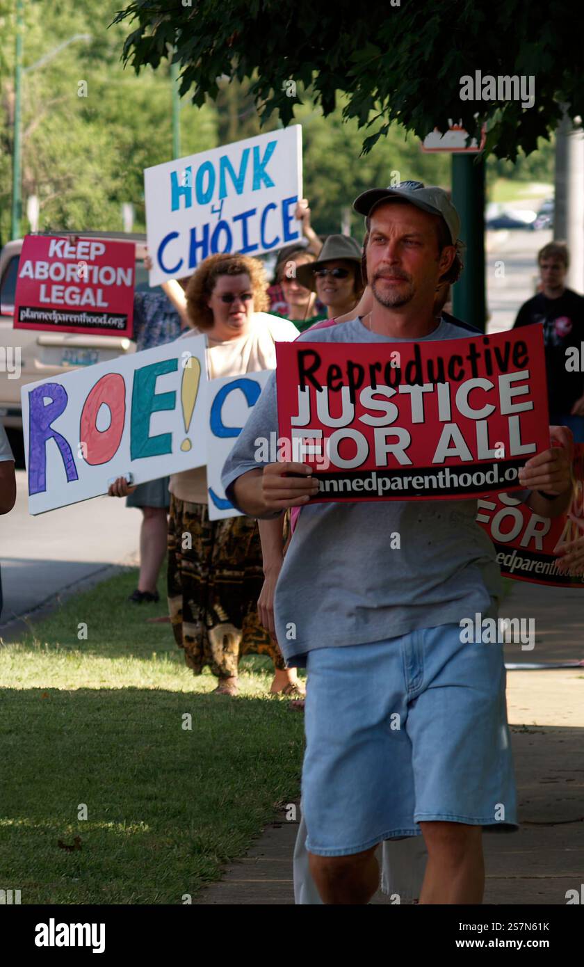 A man joins pro-Abortion rights advocates holding signs encouraging ...
