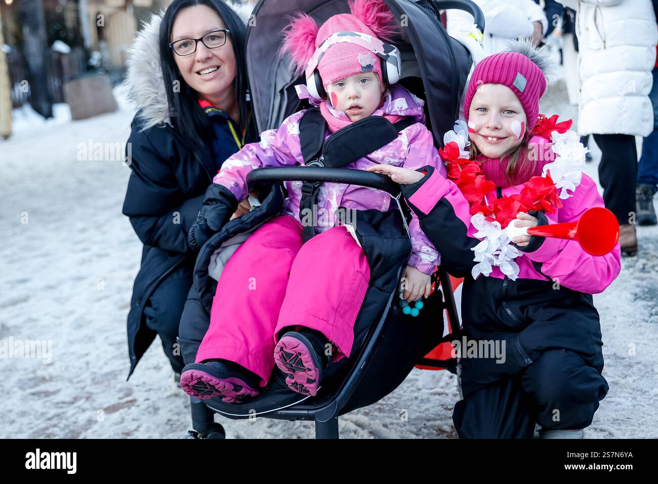 Sport fans wearing Polish national colours pose during FIS Ski Jumping ...