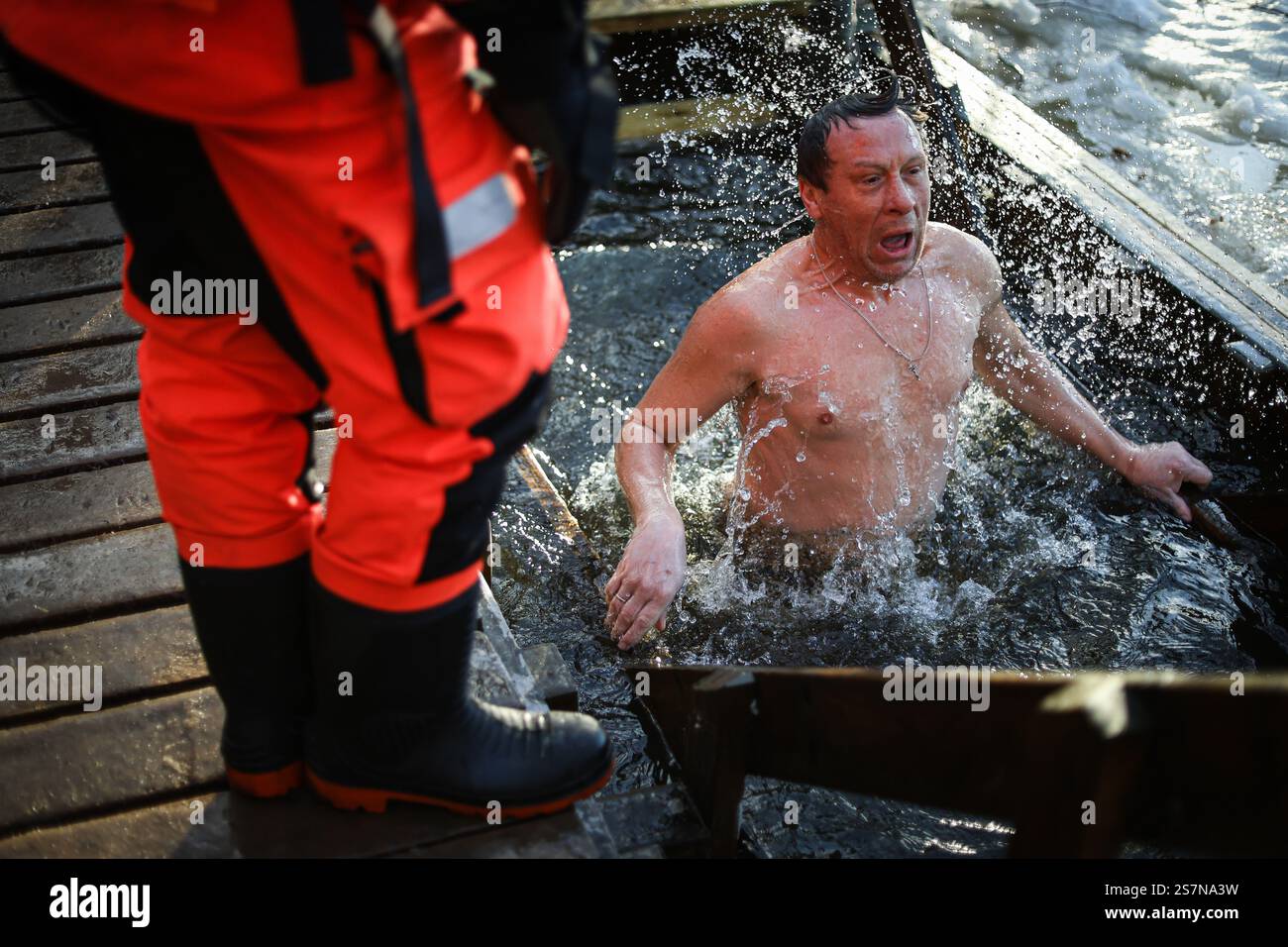 A religious man seen during the Epiphany bathing in a font on the ...