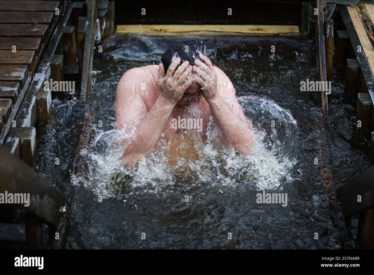 A religious man seen during the Epiphany bathing in a font on the ...