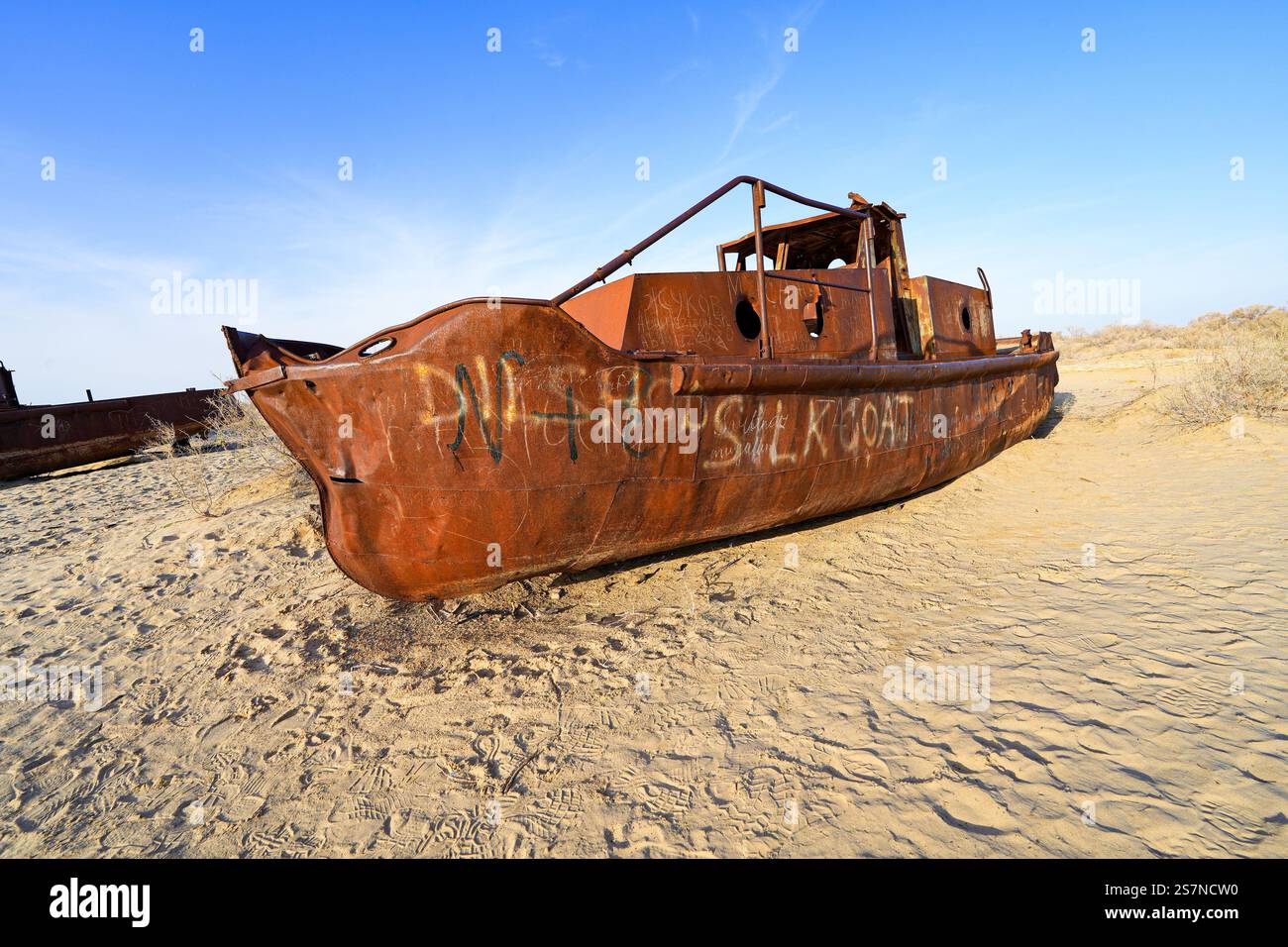 Rusty shipwreck lying on the seabed of the dried-up Aral Sea in Moynaq ...