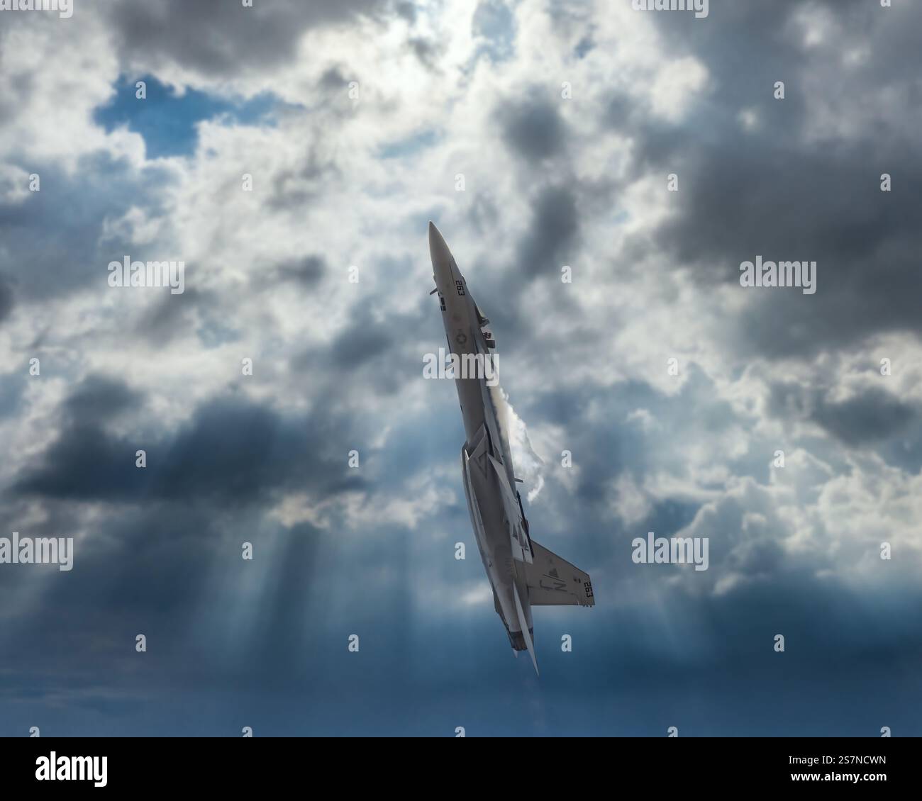 American Fighter Jet Flying Through Dramatic Clouds Stock Photo - Alamy