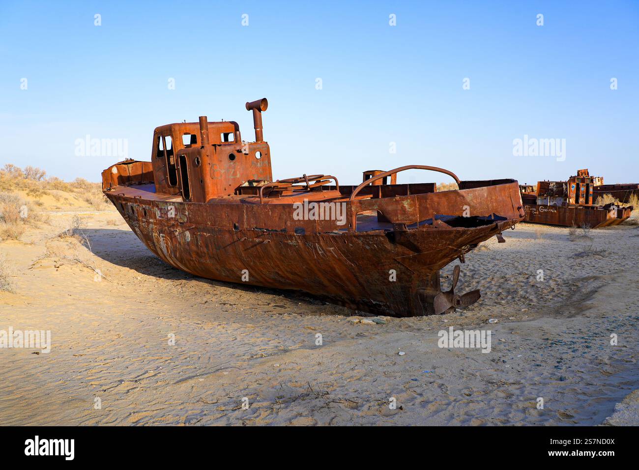 Rusty shipwreck lying on the seabed of the dried-up Aral Sea in Moynaq ...
