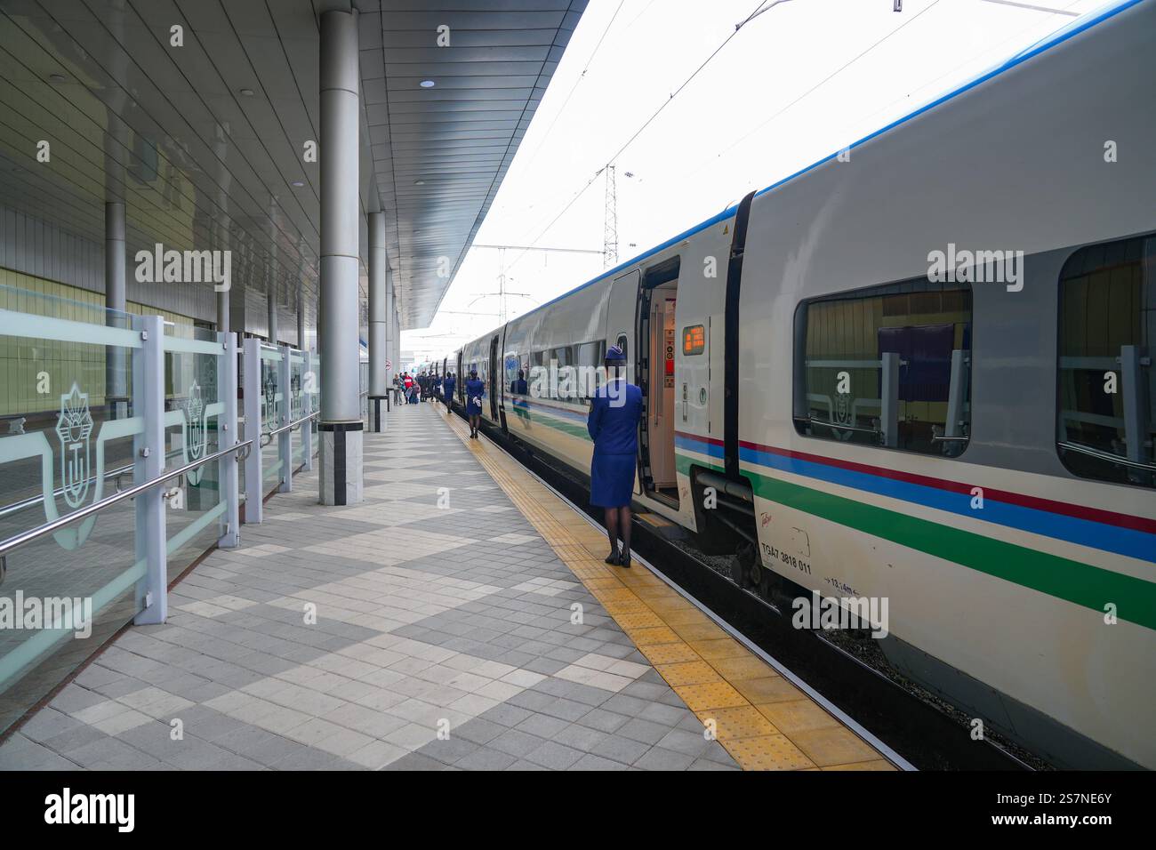 Hostess in uniform on the platform of Tashkent train station, by a ...
