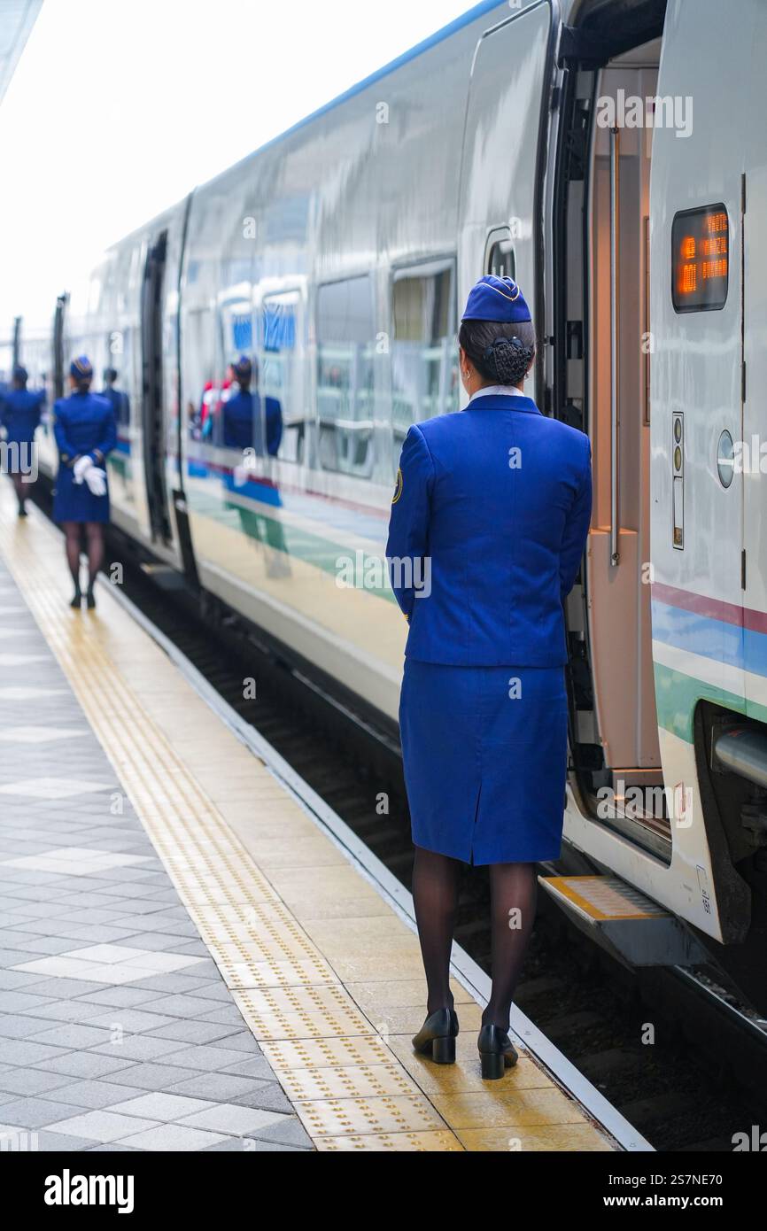 Hostess in uniform on the platform of Tashkent train station, by a ...
