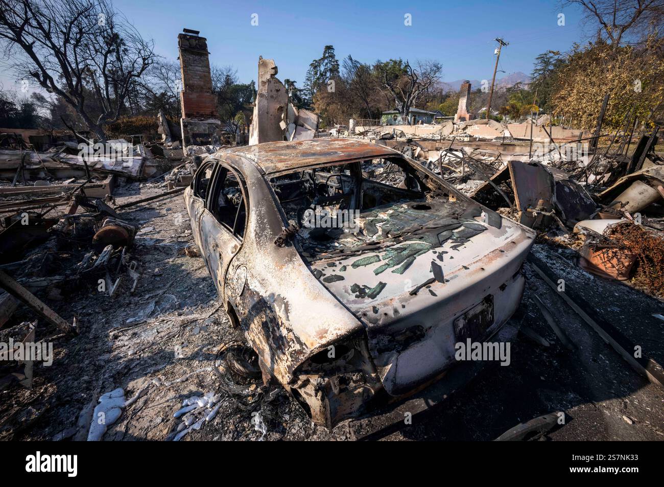 Altadena, California, USA. 19th Jan, 2025. A vehicle and structures ...