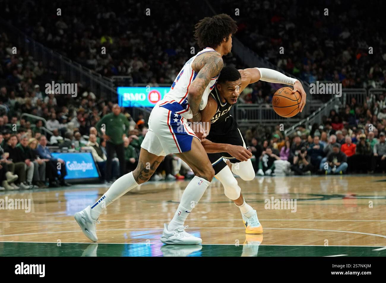 Milwaukee Bucks' Giannis Antetokounmpo, right, drives to the basket ...
