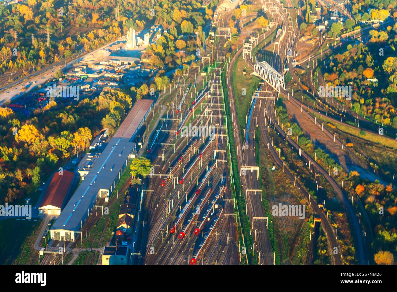Aerial view of bustling railway hub surrounded by vibrant autumn ...