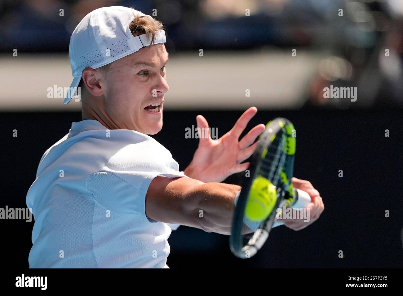 Holger Rune of Denmark plays a forehand return to Jannik Sinner of Italy during their fourth ...