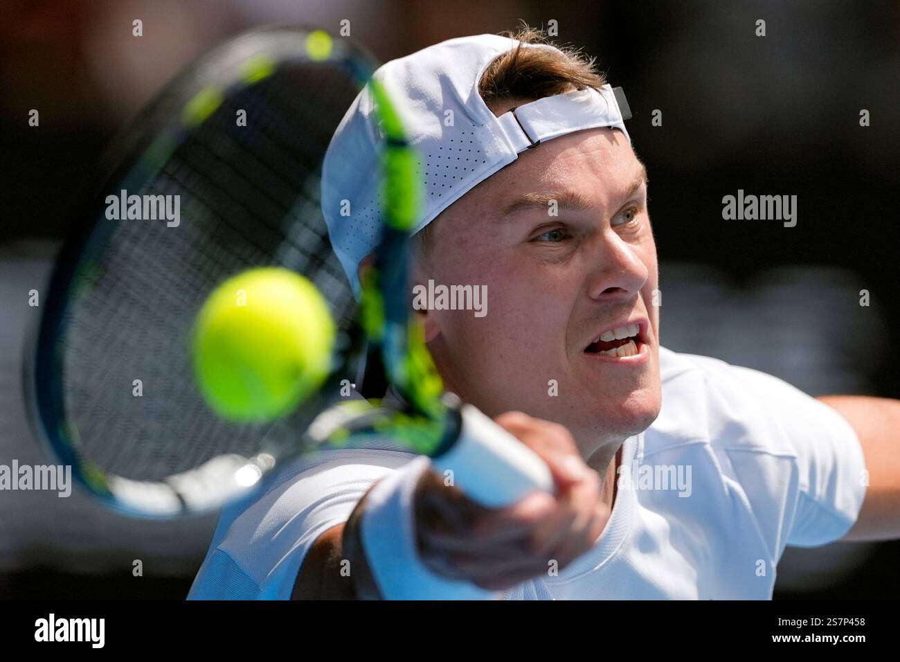 Holger Rune of Denmark plays a forehand return to Jannik Sinner of Italy during their fourth ...
