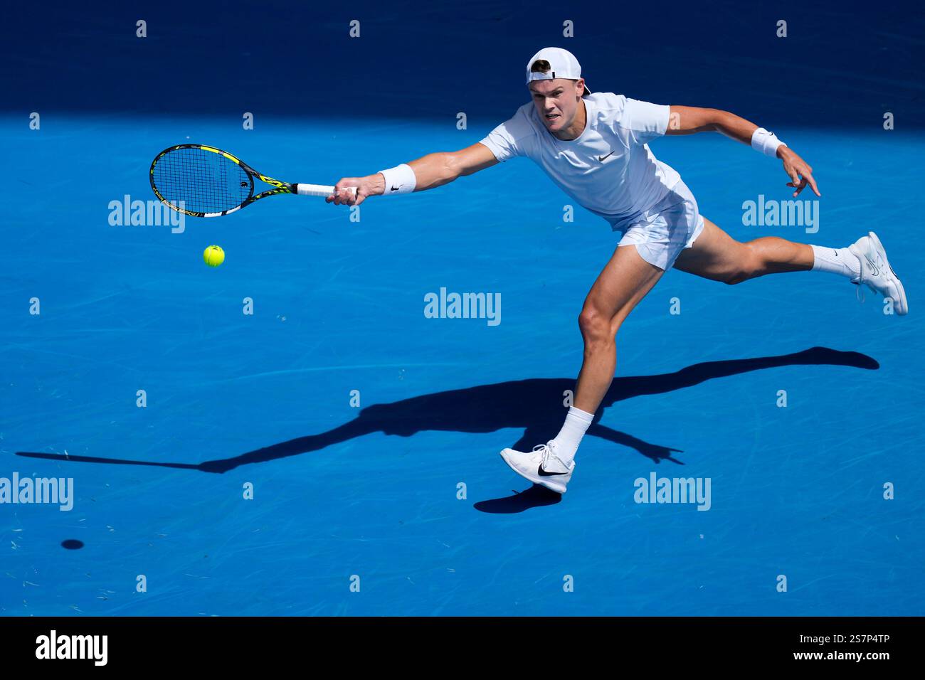 Holger Rune of Denmark plays a forehand return to Jannik Sinner of Italy during their fourth ...