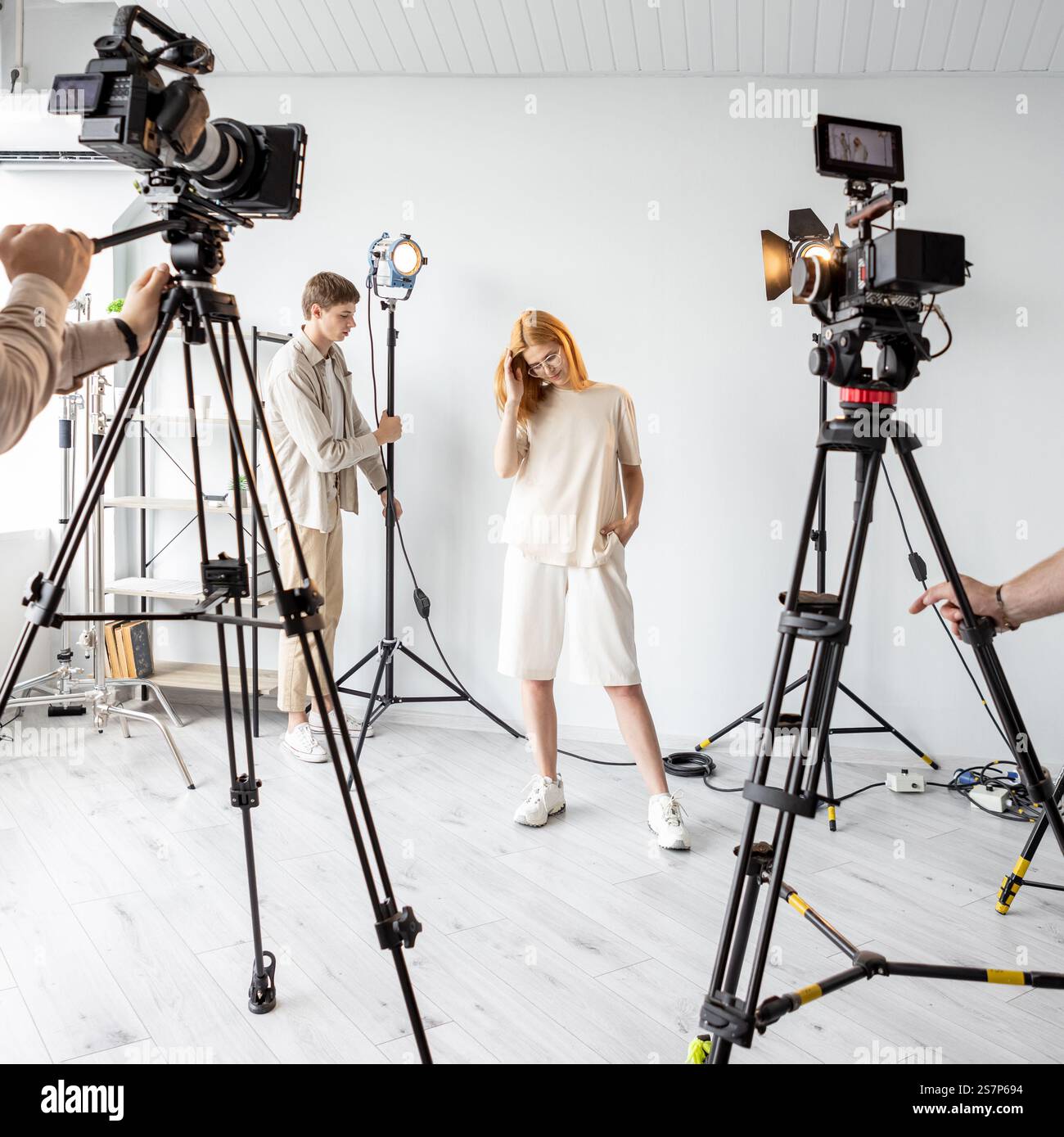 Model preparing. Video camera studio. Art team configure equipment for ...