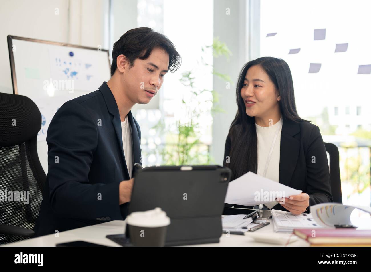 Two businesspeople are meeting in a meeting room, having a nice ...