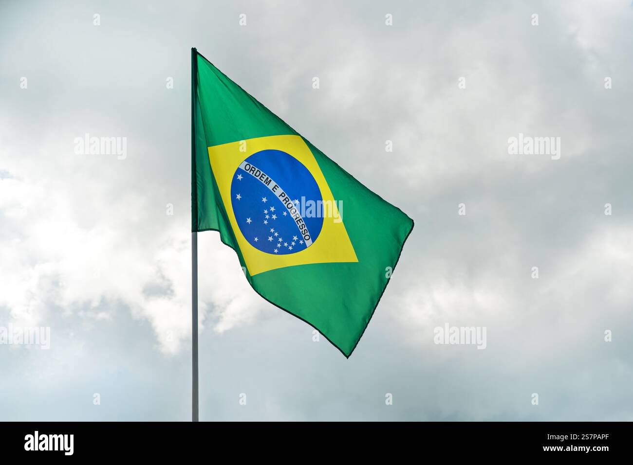 Flag on Brazil flag pole and blue sky Flag of Brazil fluttering in blue ...