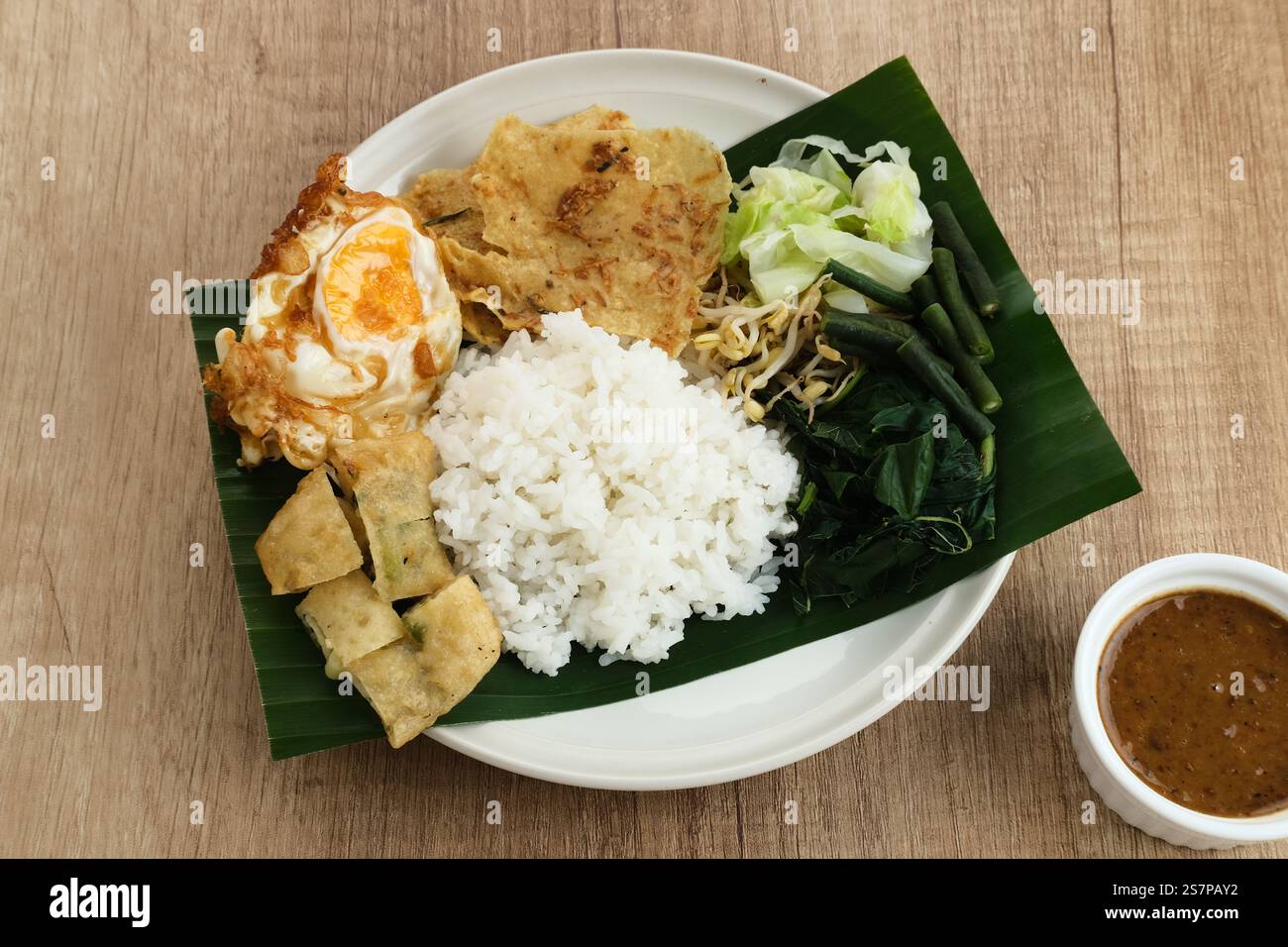 Nasi Pecel, a traditional Javanese rice with vegetable salad and peanut ...
