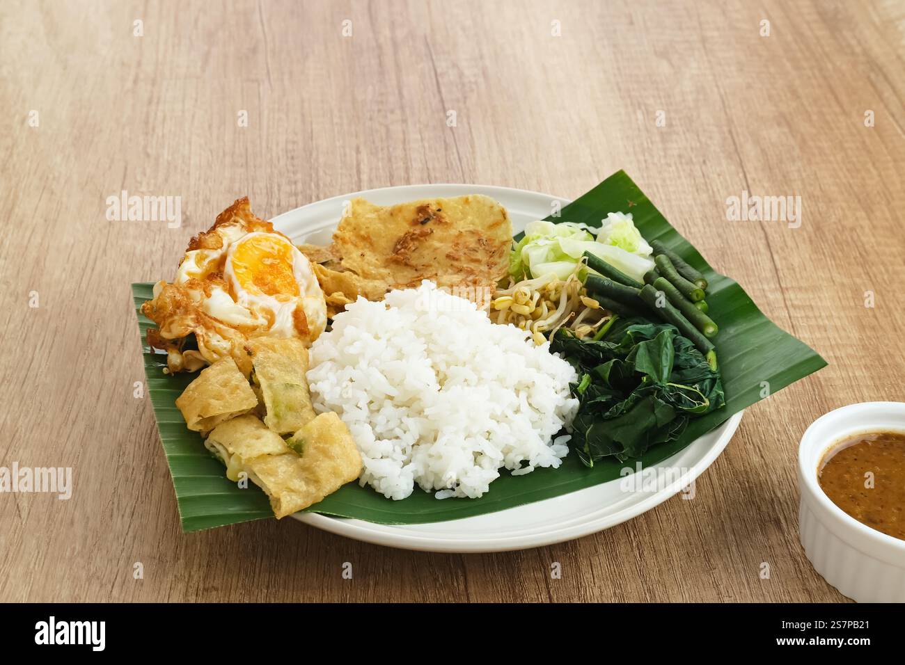Nasi Pecel, a traditional Javanese rice with vegetable salad and peanut ...
