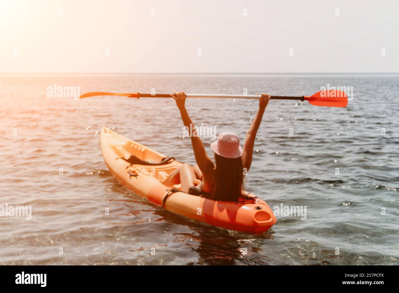 Kayaking Woman Ocean Sunset - Enjoying summer paddling adventure at sea ...
