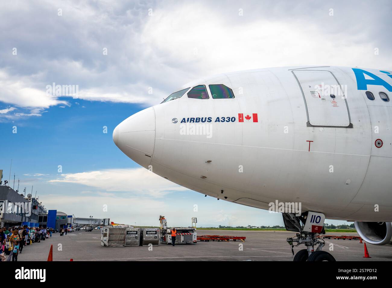 A smiling Air Transat pilot waves from his cockpit window while waiting ...