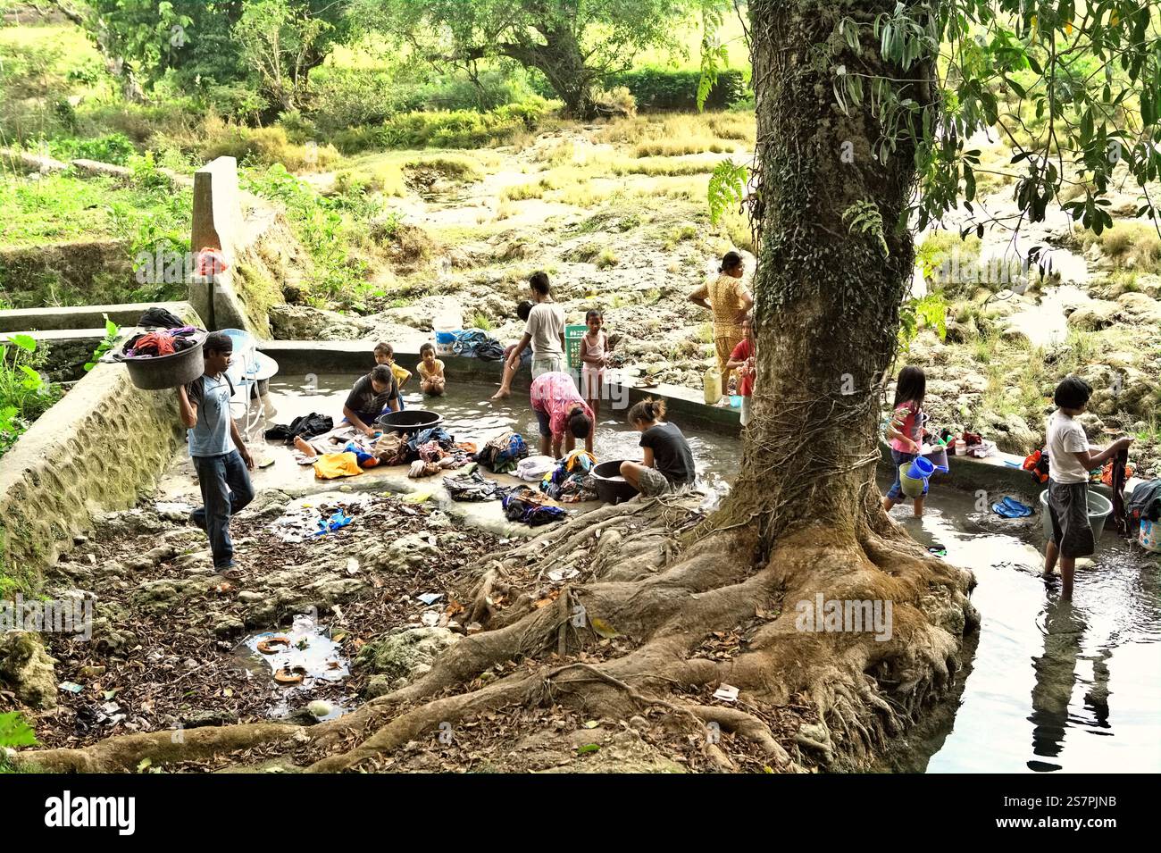 Women washing clothes at an irrigation canal near Waikelo Sawah, a rare ...