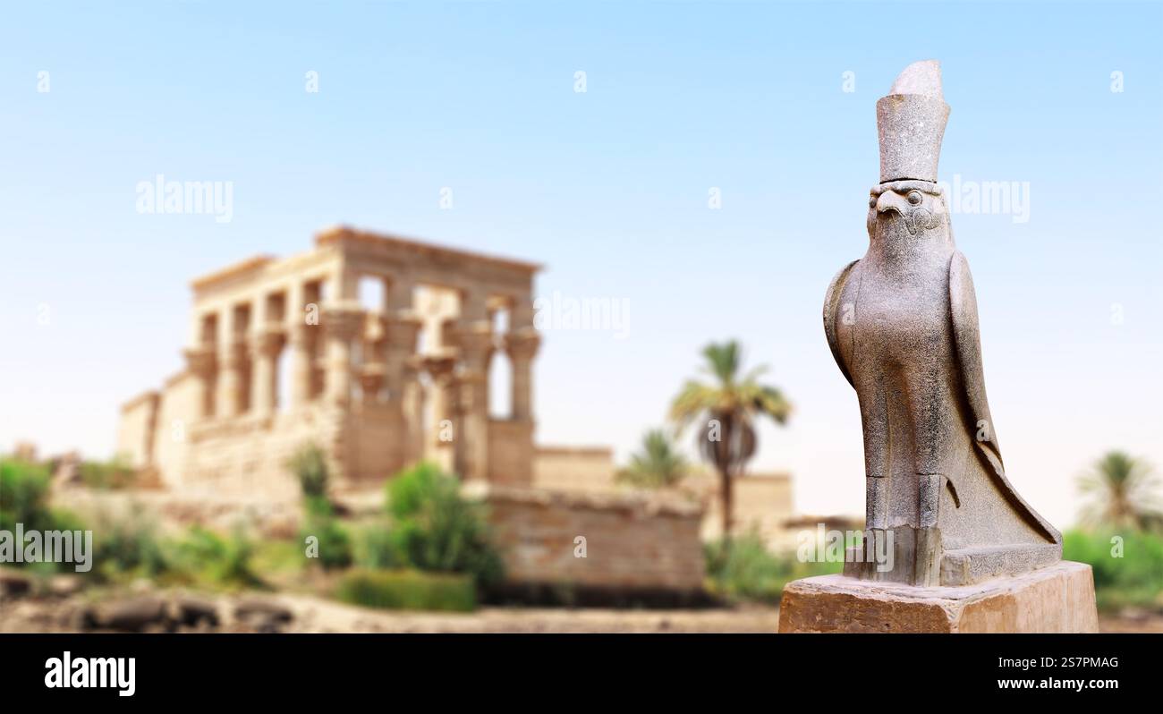 Horizontal banner with granite statue of falcon God Horus, palm and ...