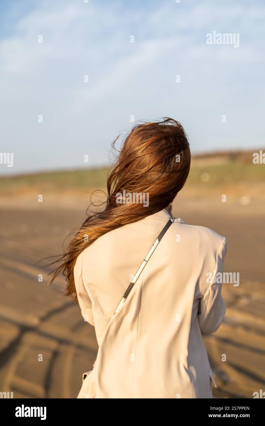 A Japanese woman in her 20s wearing white clothes spending time in the ...