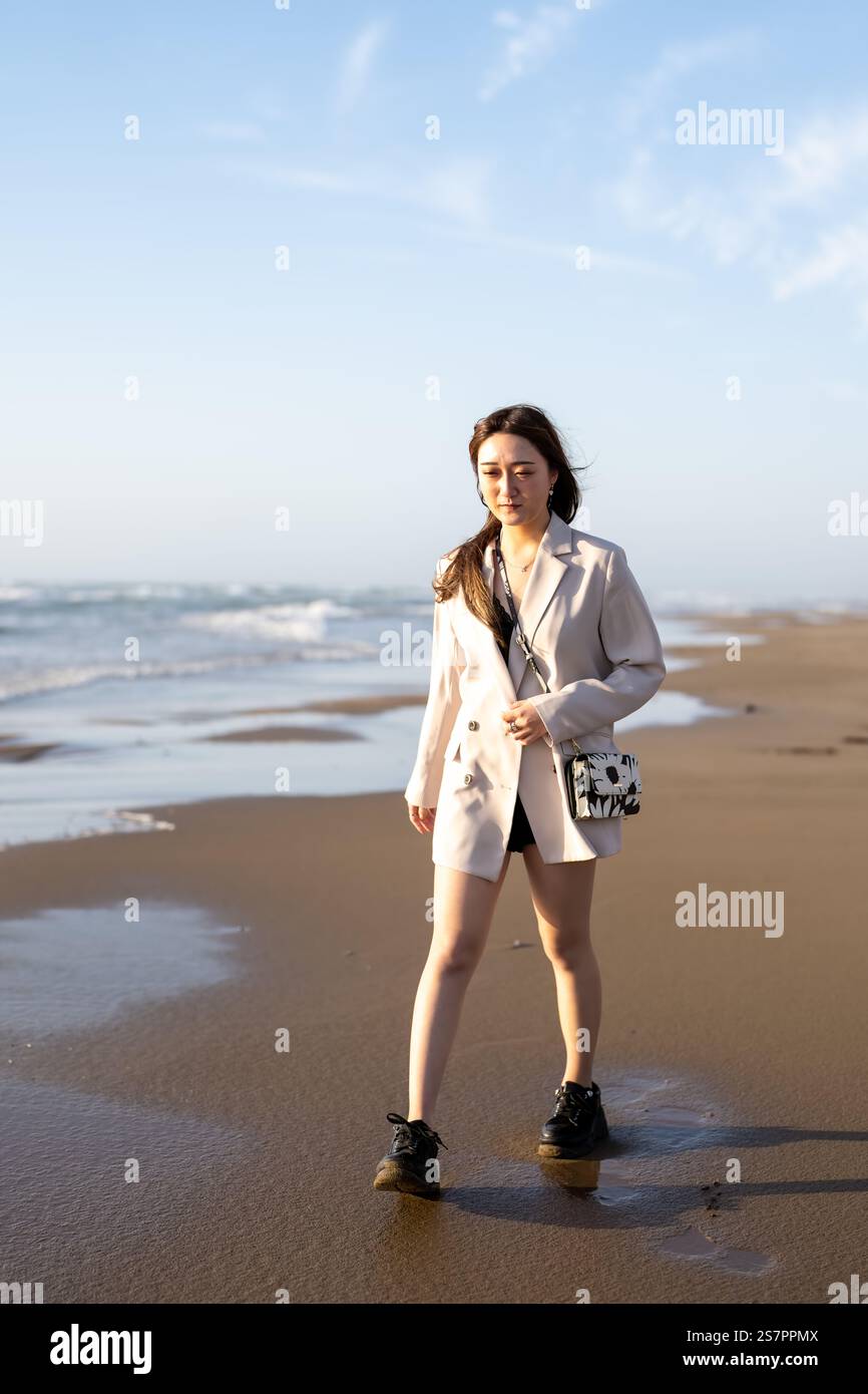 Japanese woman in white clothes spending time in the sunset on a long ...