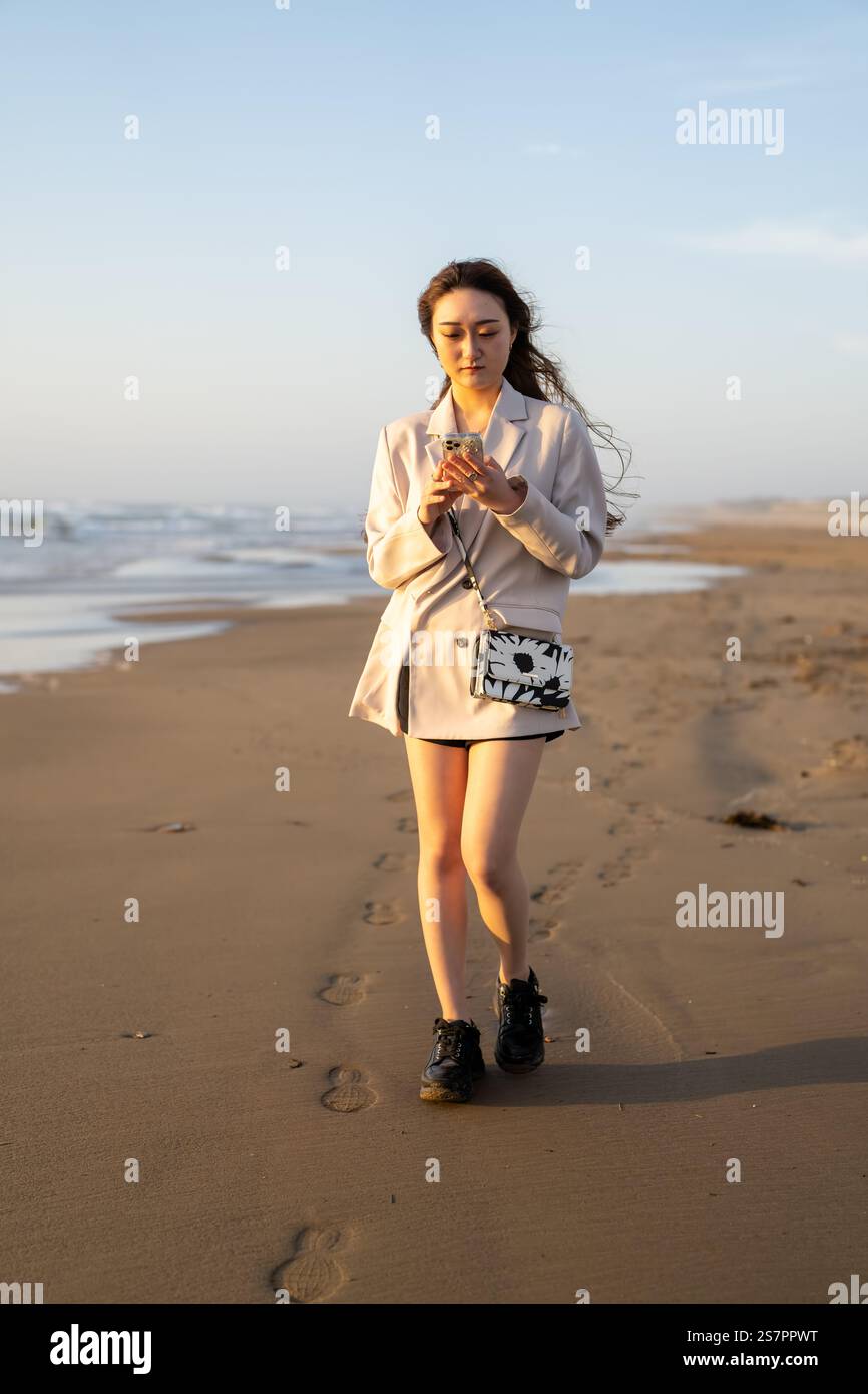 A Japanese woman in her 20s wearing white clothes spending time in the ...