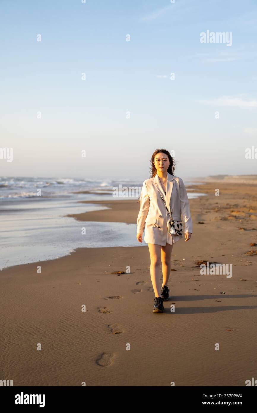 A Japanese woman in her 20s wearing white clothes spending time in the ...