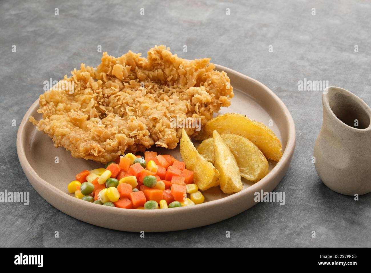 Crispy Chicken Steak with french fries and vegetables Stock Photo - Alamy