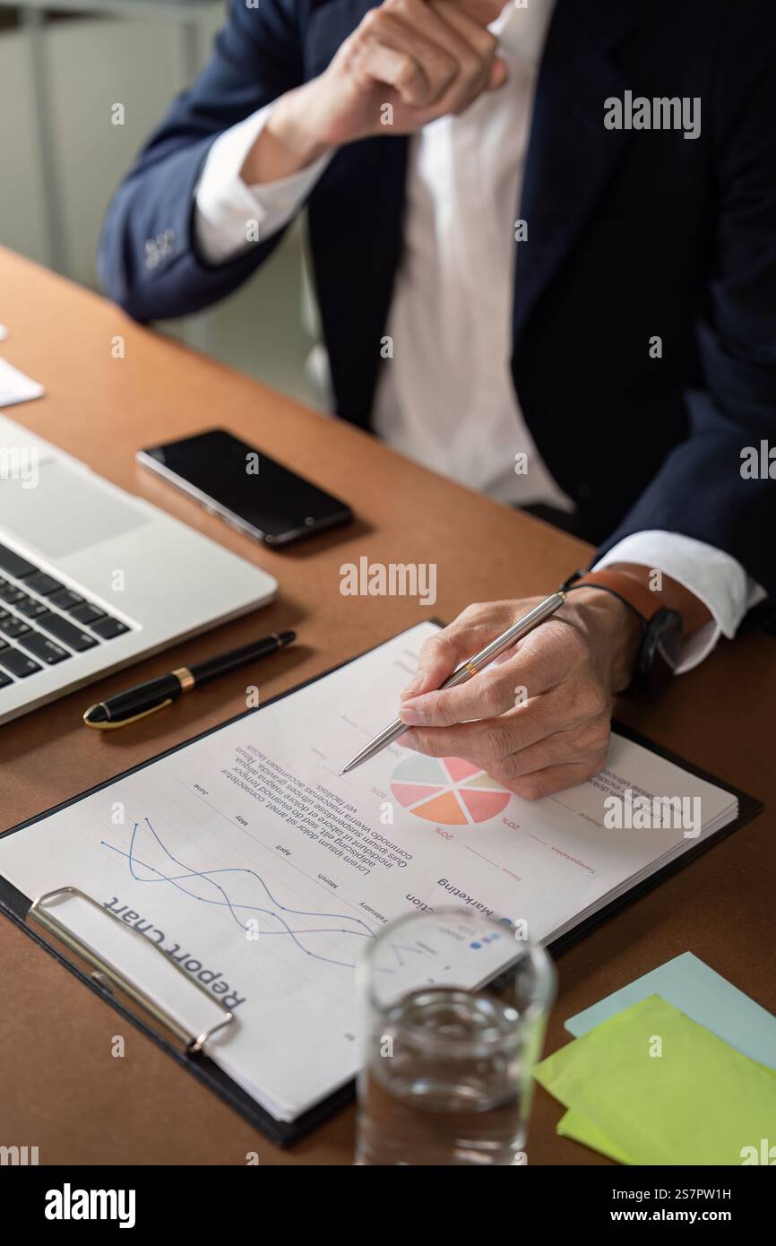 Senior financial analyst preparing report with charts and graphs in ...