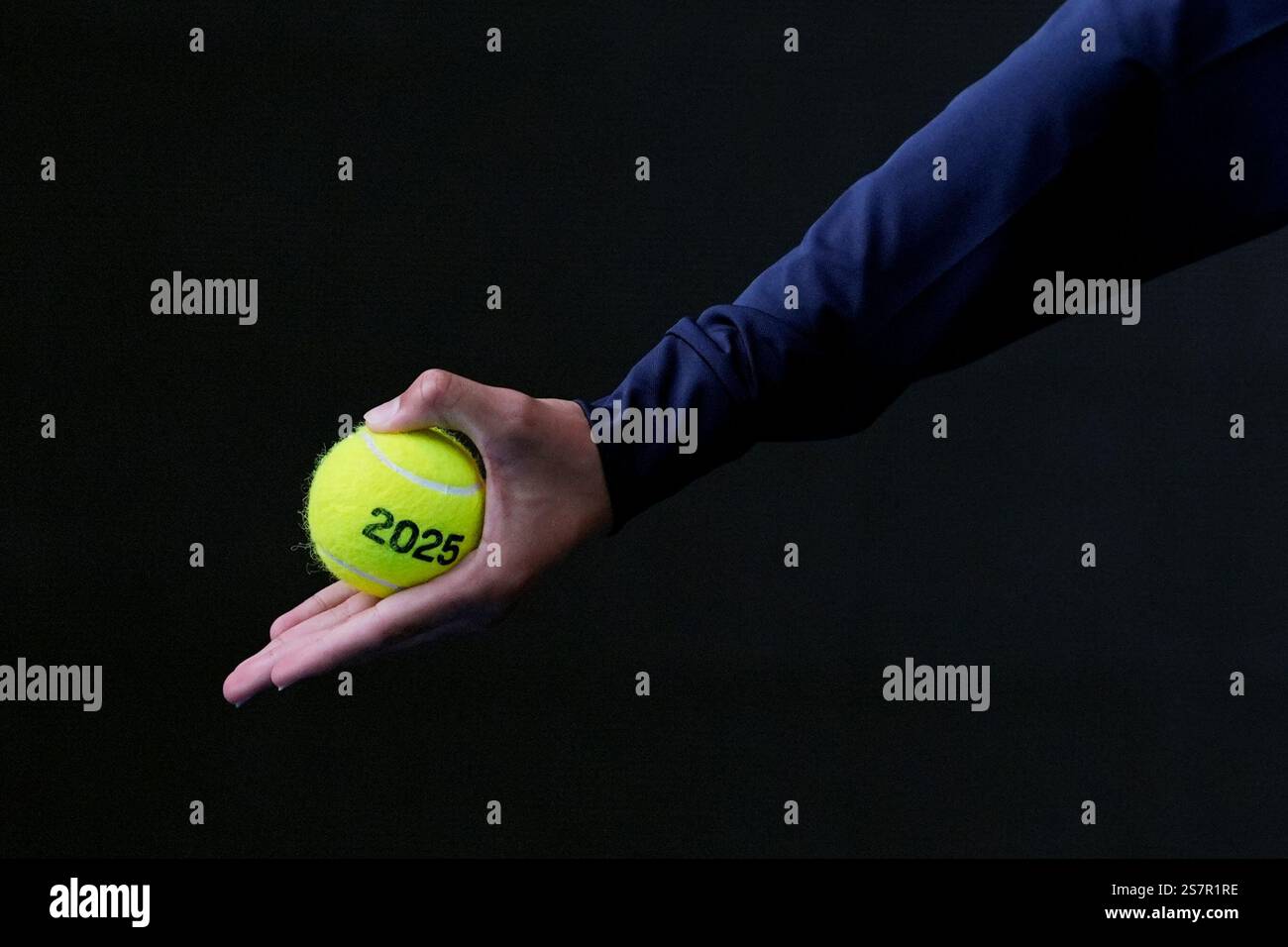 A ball kid holds out a ball during the fourth round match between ...