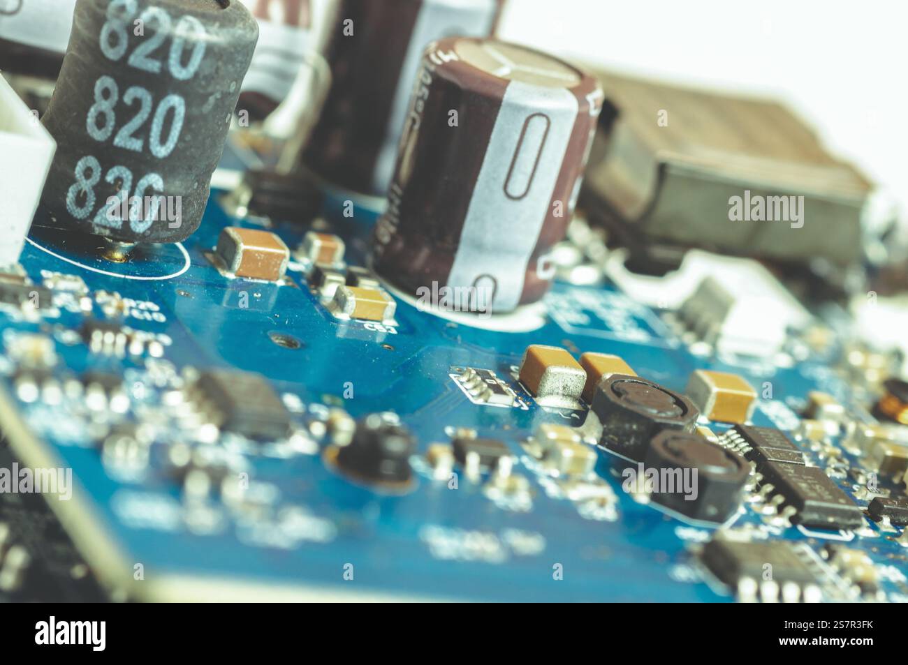 Electronic components, chips and capacitors on the blue pcb, close up view. Technology concept ...