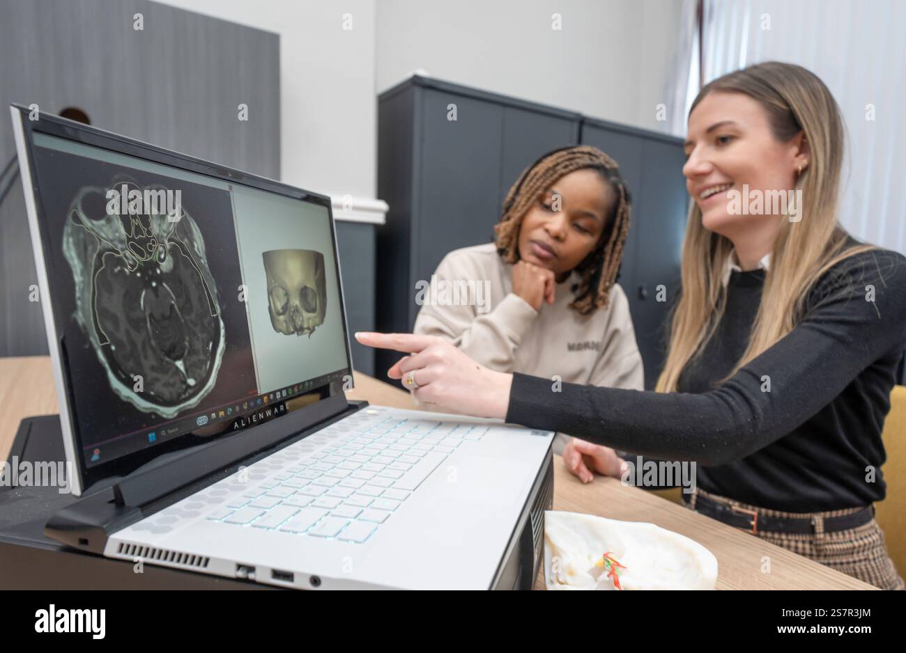 Patient Ruvimbo Kaviya (left) and Biomedical Engineer Lisa Ferrie look ...