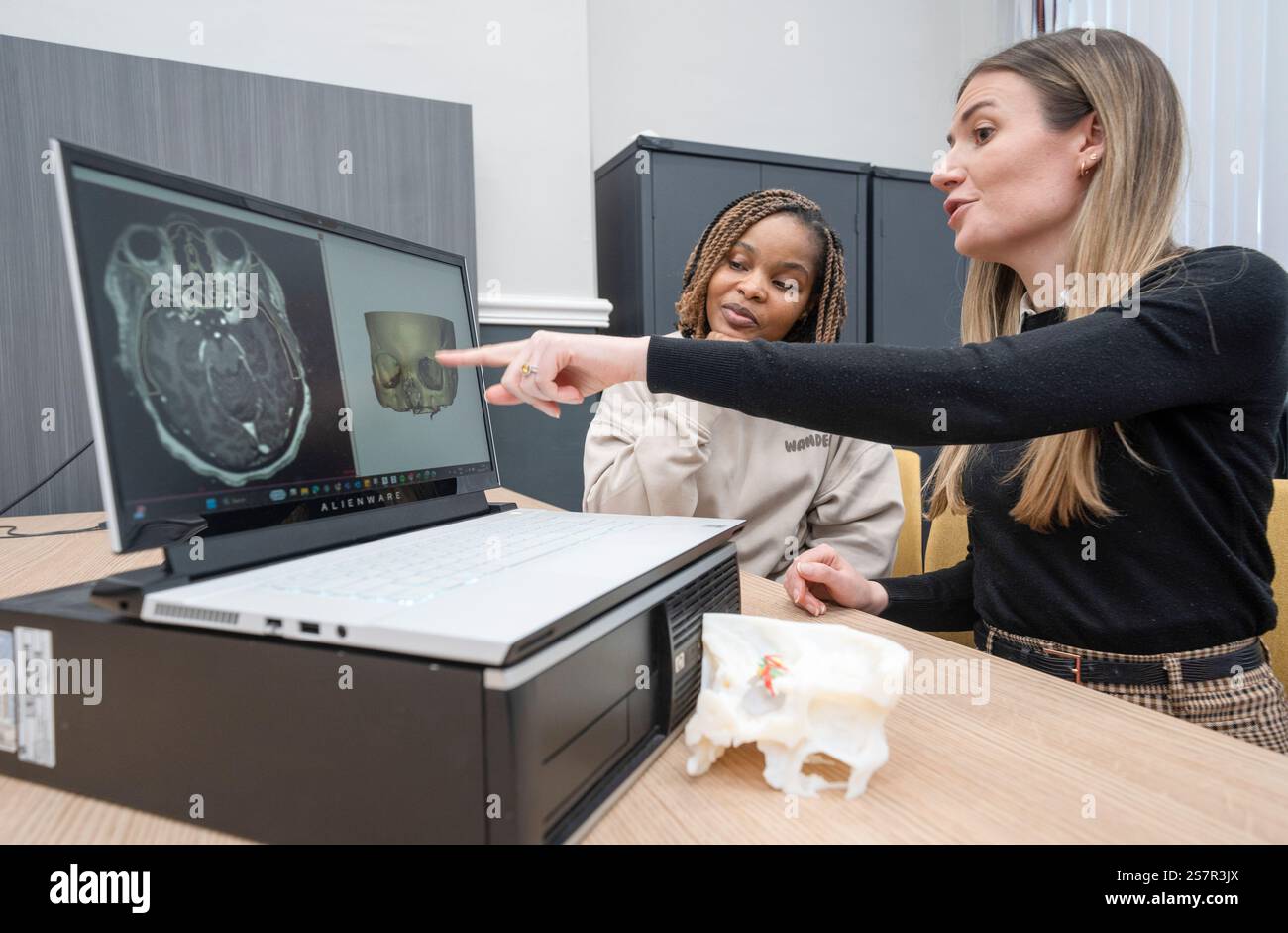 Patient Ruvimbo Kaviya (left) and Biomedical Engineer Lisa Ferrie look ...