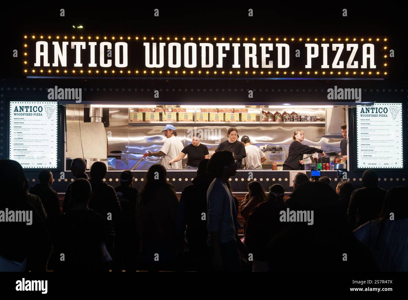 A mobile woodfired pizza stall serving customers at night. Sydney ...