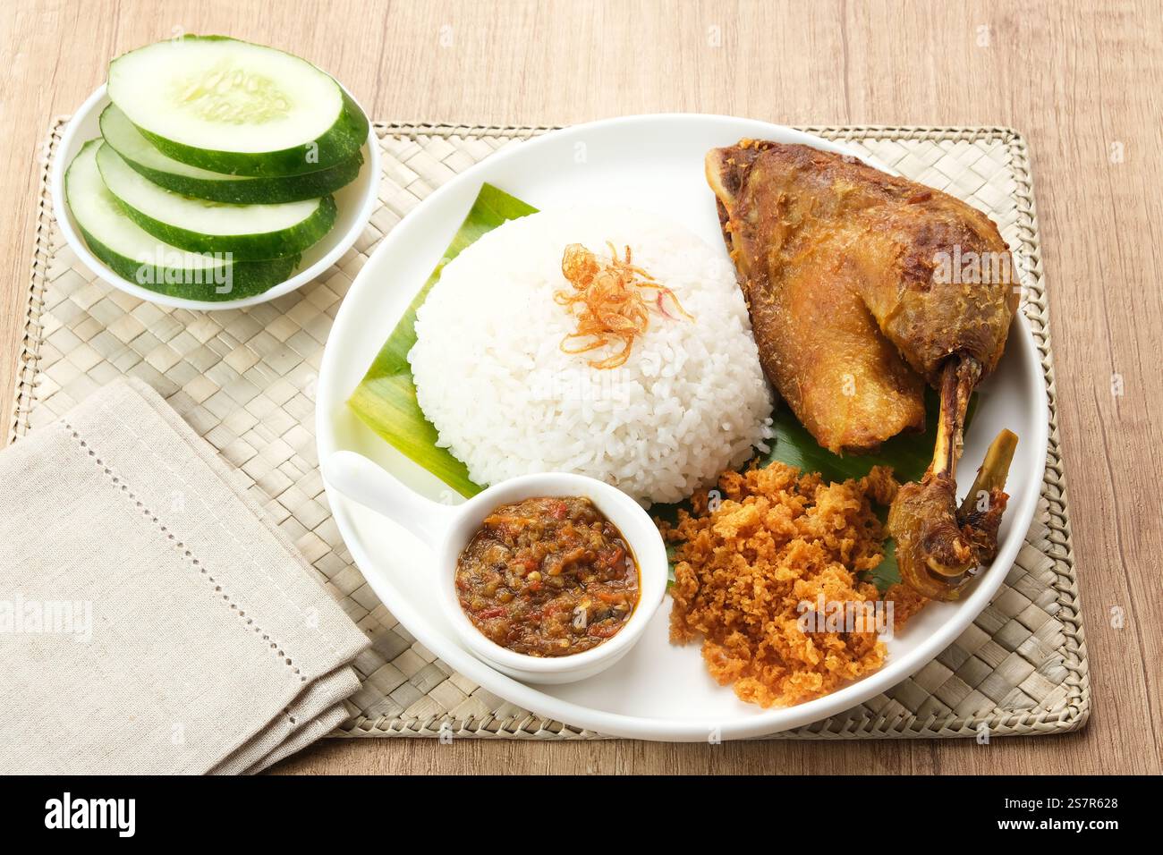 Bebek Goreng, served with chili sauce (sambal) and cucumber. Indonesian ...