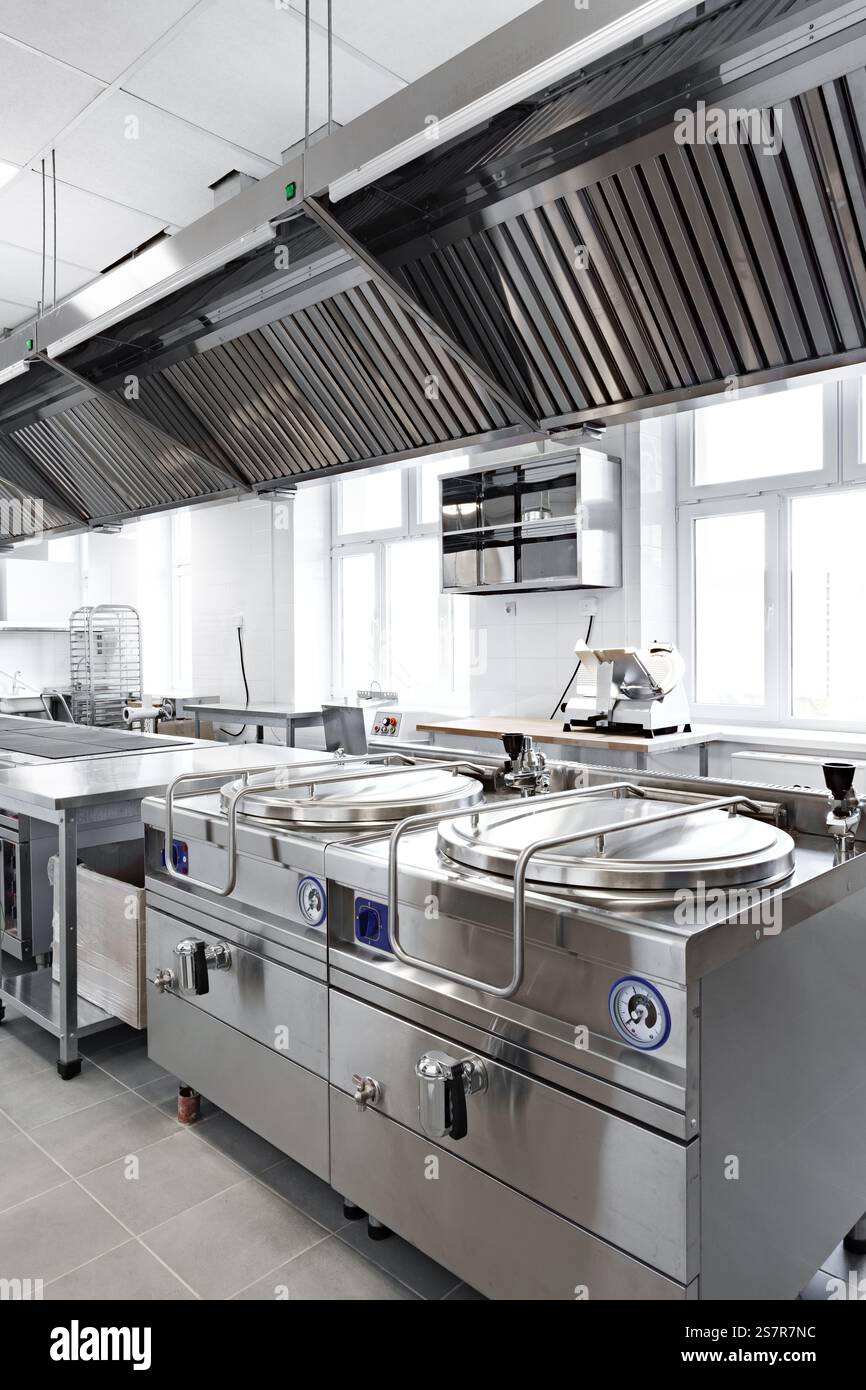 Modern commercial kitchen equipped with stainless steel appliances and ...