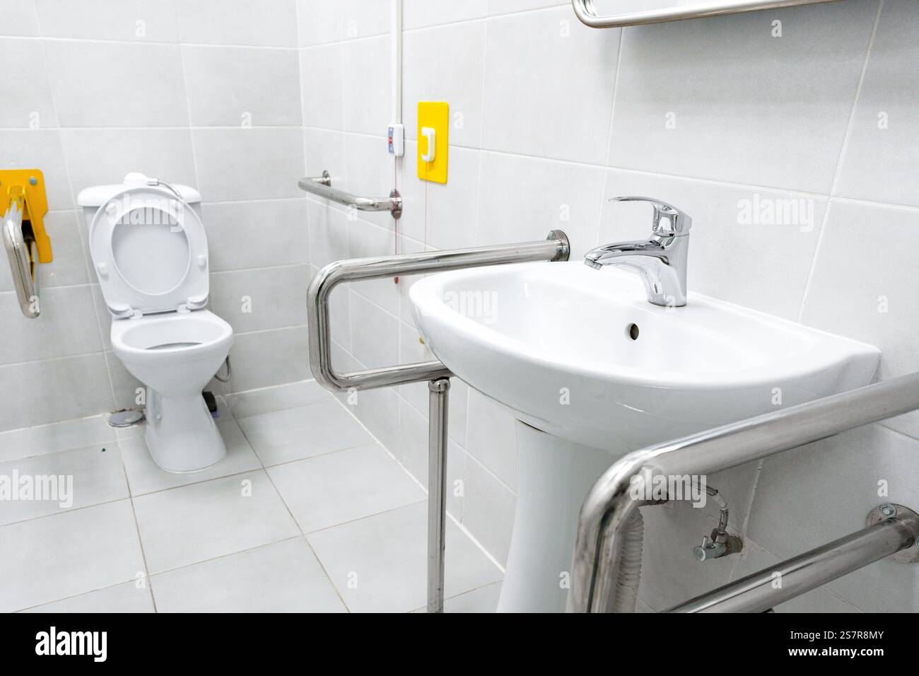 Accessible restroom featuring grab bars and modern fixtures for ...